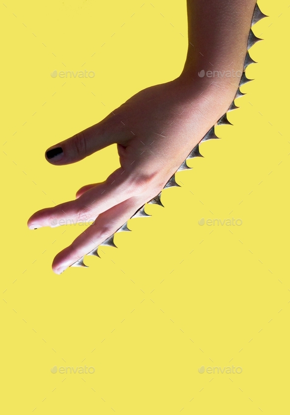 Spikes on hand on yellow background Stock Photo by mirarahneva | PhotoDune