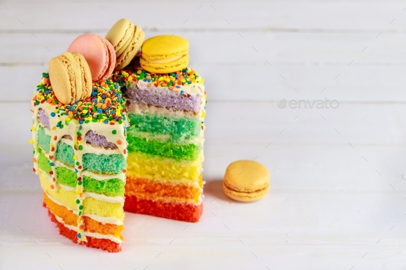 Rainbow sponge cake decorated with color macaroons. Stock Photo by ...