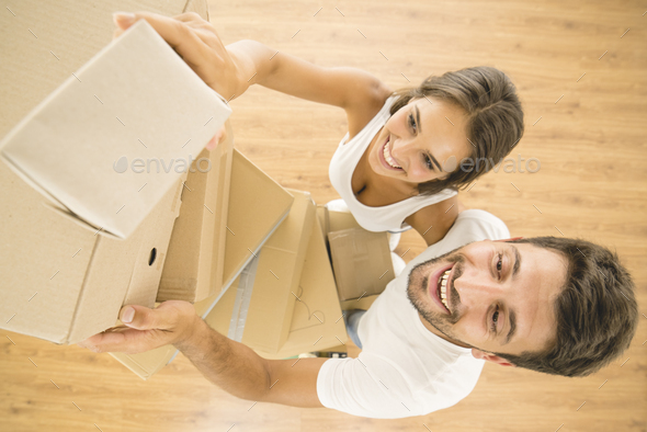 The man and woman hold a boxes. view from above Stock Photo by artemp3