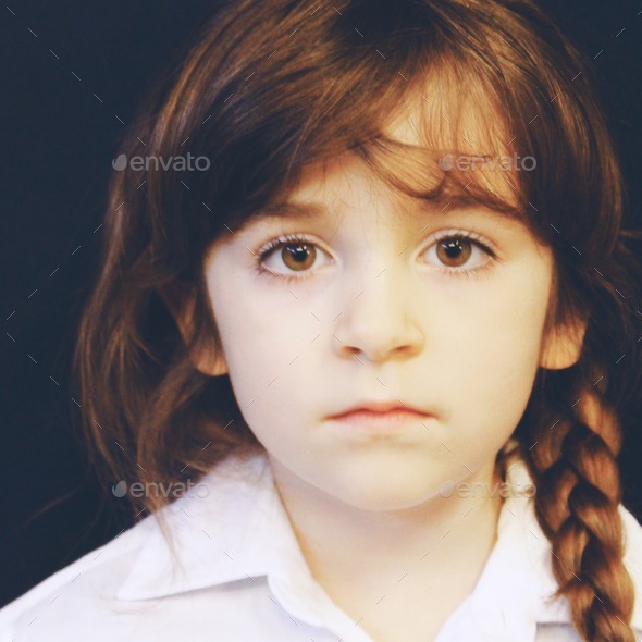 Portrait of girl staring into camera against black background. Stock ...