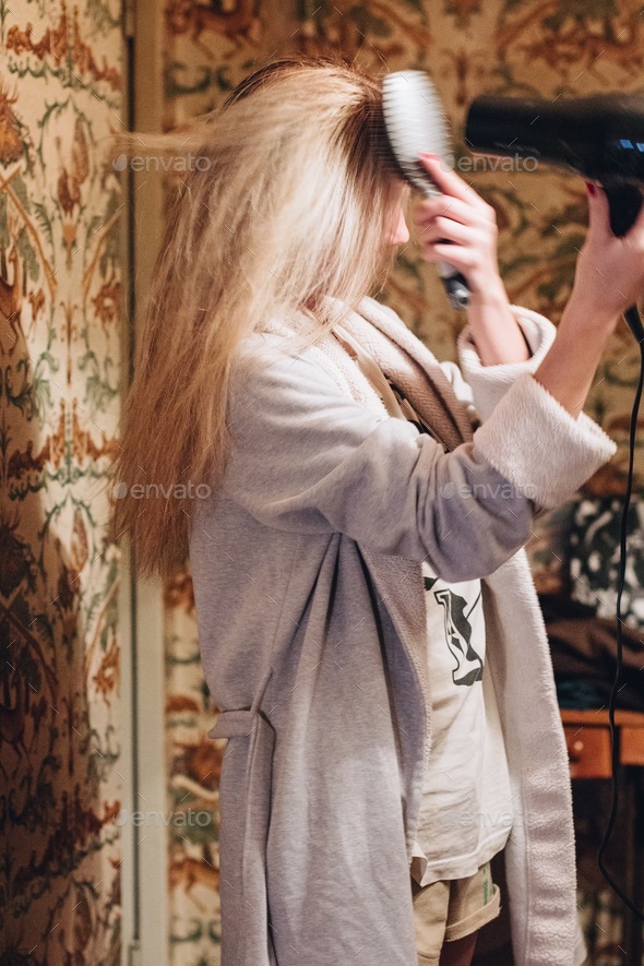 Morning routine / woman doing her hair Stock Photo by LesiaScotch