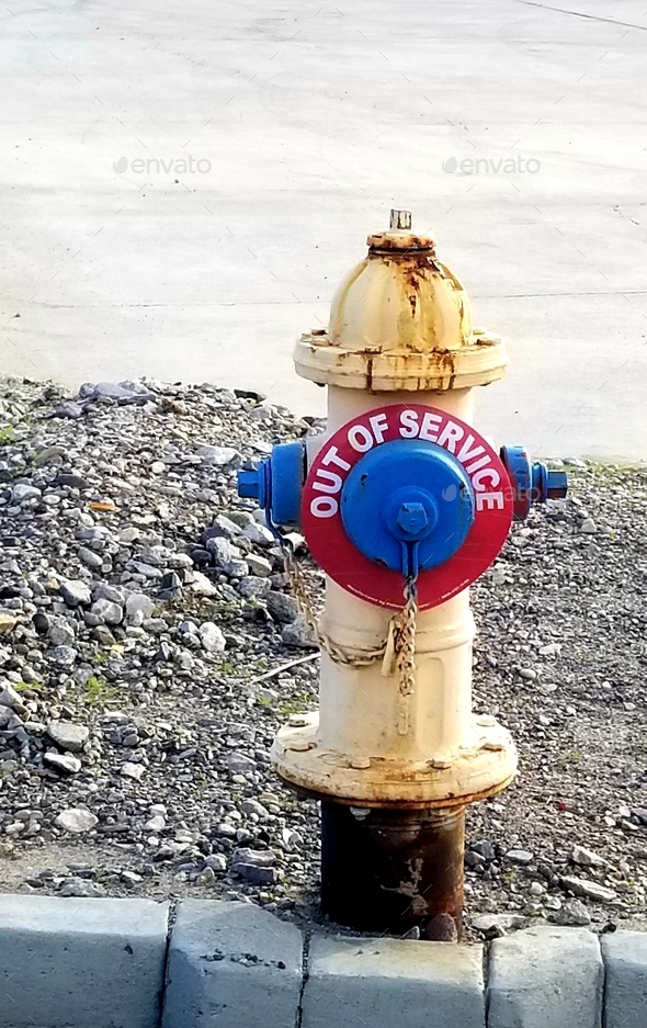Out Of Service! An old yellow fire hydrant with an 'Out of Service ...