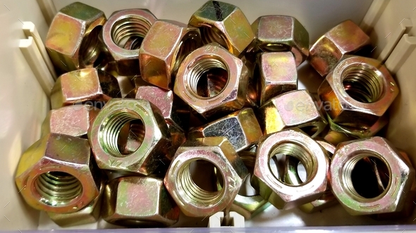 GOLD! Gold tone metal nuts used on gold tone bolts in construction and ...