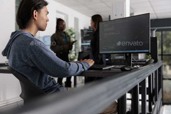 Asian app developer analyzing compiling html code Stock Photo by DC_Studio