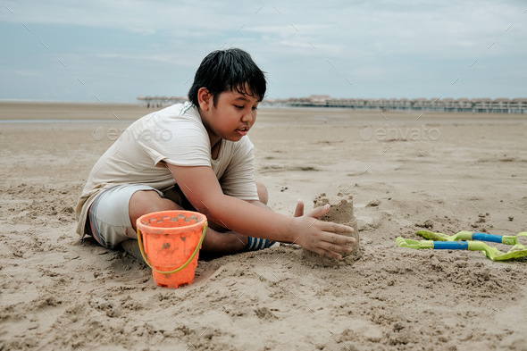 A boy build sand castle at the beach Stock Photo by nadiasaleh86 ...