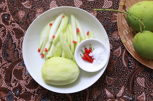 Sliced young mango with chili and salt Stock Photo by myrageraldinej