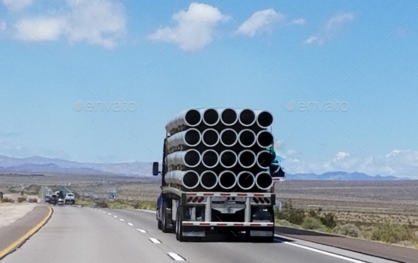 Big Rig Semi Truck Hauling Large Metal Pipe! Stock Photo by AZ-BLT