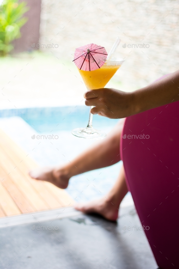 Legs of a girl who drinks a cocktail Stock Photo by jdvolcan | PhotoDune
