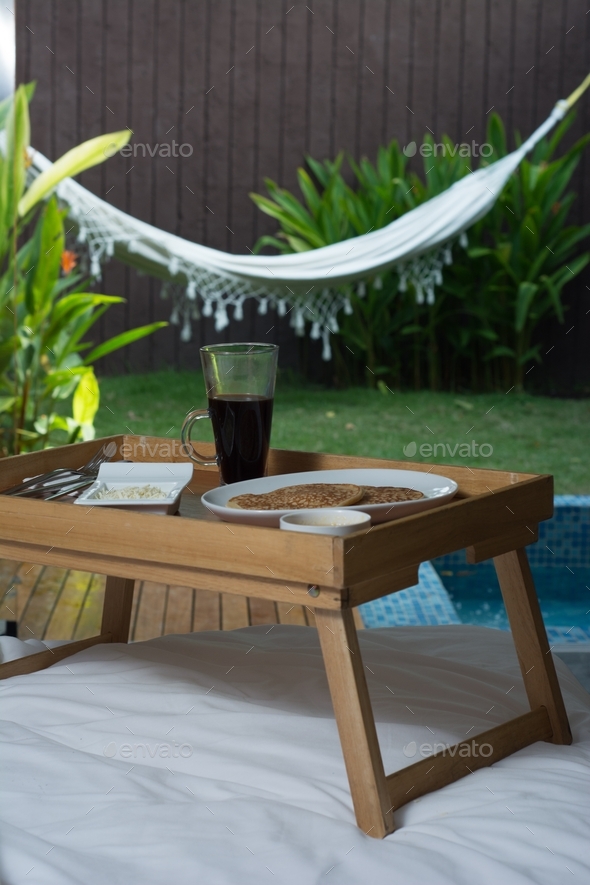 Breakfast table in bed. Pancakes, coffee. Yard. Hotel room Stock Photo ...