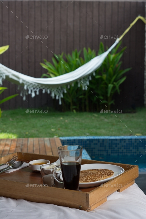 Breakfast table in bed. Pancakes, coffee. Yard. Hotel room Stock Photo ...
