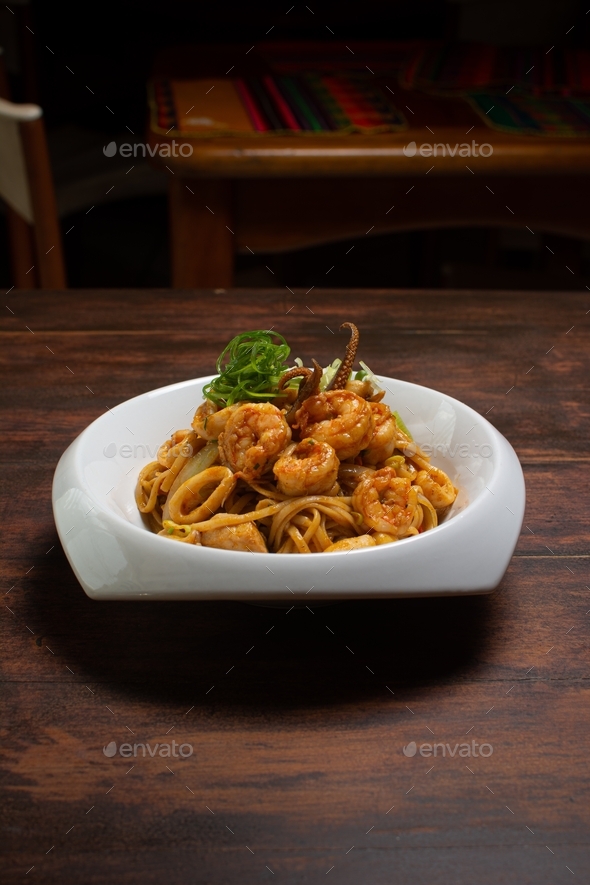 Tallarin saltado Fruto del Mar. Traditional Peruvian pasta with seafood ...