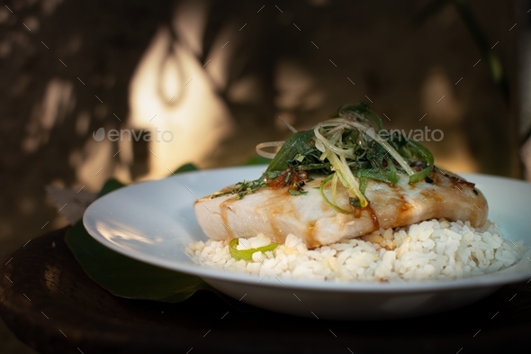 Steamed fish fillet, over white rice, with chives topping and honey and ...