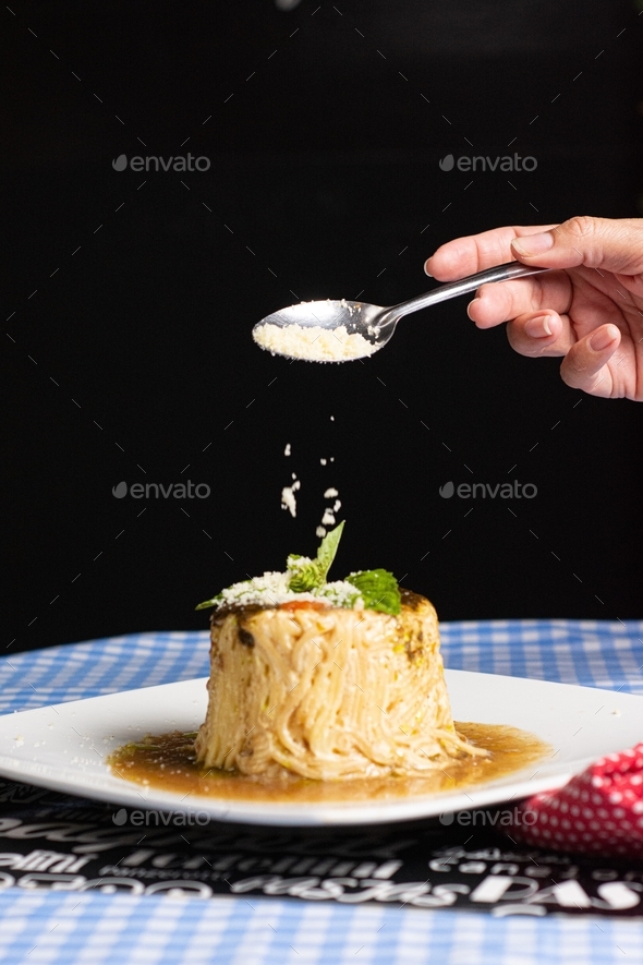 Pasta timbale. Spaghetti with sauce. putting cheese on pasta Stock ...