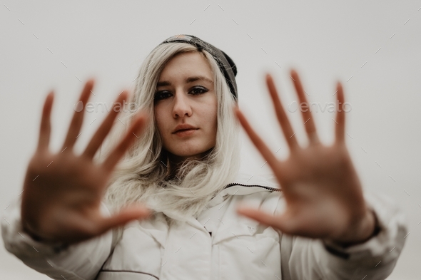 Light and airy photo of a girl with her hands facing camera. Blurred ...