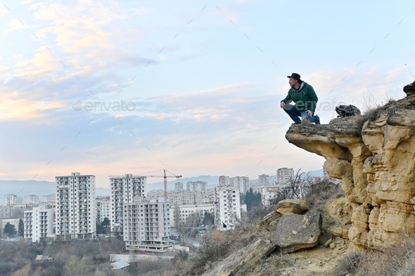 Man sitting on a cliff Stock Photo by nodar77 | PhotoDune