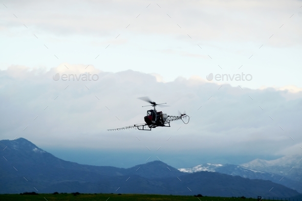 Spray helicopter for farming in flight Stock Photo by langalvezjen