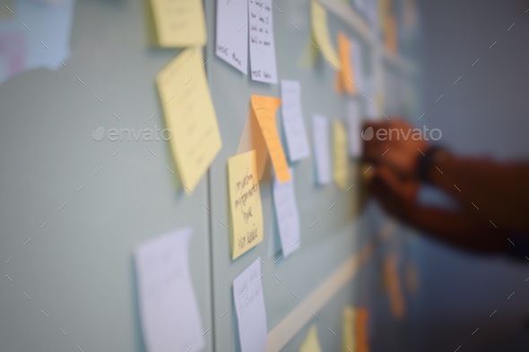 Post it’s being placed on a wall during design thinking workshop Stock ...