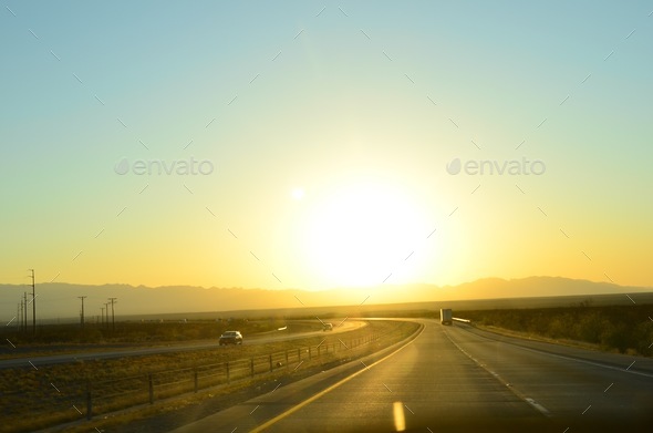 Nearly empty freeway with only 3 vehicles on both sides of the road ...