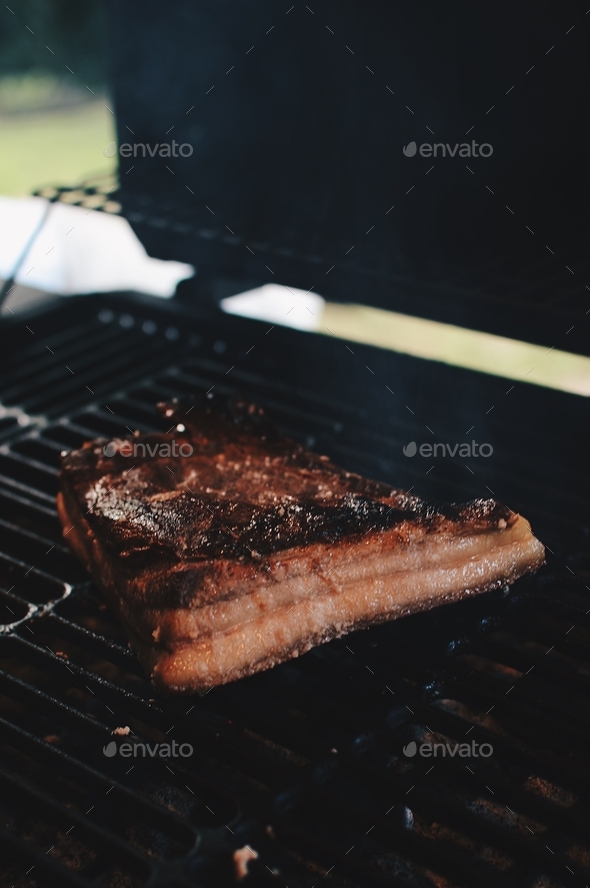 Charred pork belly slab on a charcoal grill outside Stock Photo by ...