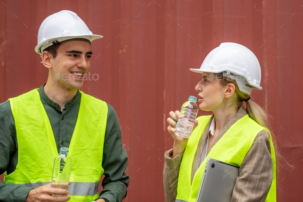 Workers taking a break from outdoor work. Worker drinking water. Stock ...