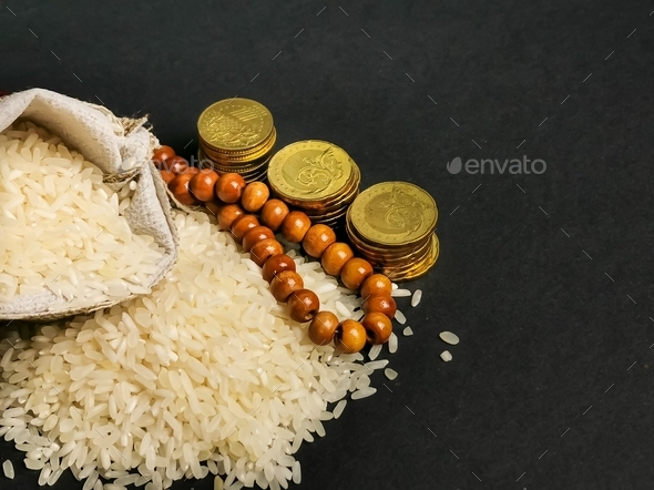Selective focus rice in sack with coins and rosary. Stock Photo by ...
