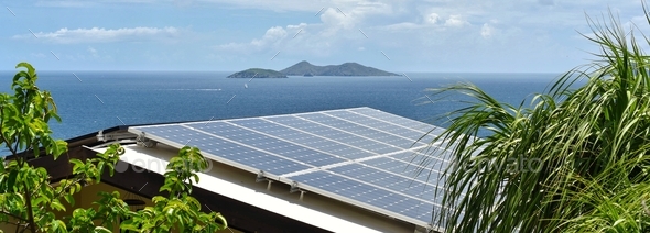 Tropical solar energy rooftop panels in a Caribbean island seaside ...