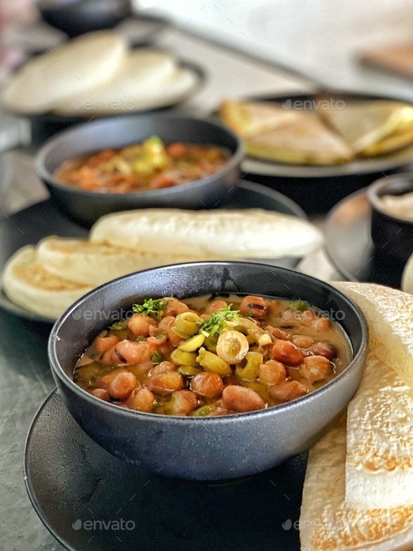 Ful is a popular Middle East dish topped with sliced olives, eaten with ...