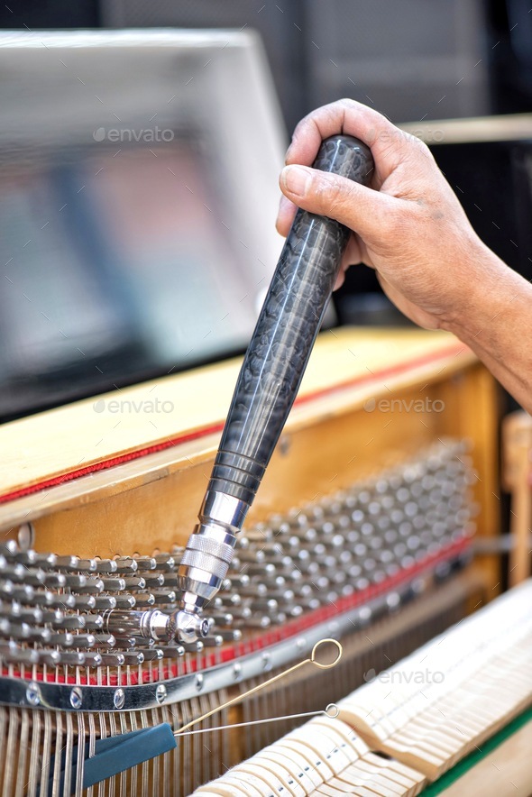 Tuning a piano with a special wrench and felt shims Stock Photo by ...
