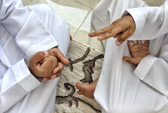 Diverse Arab children playing a traditional hand game together at a ...