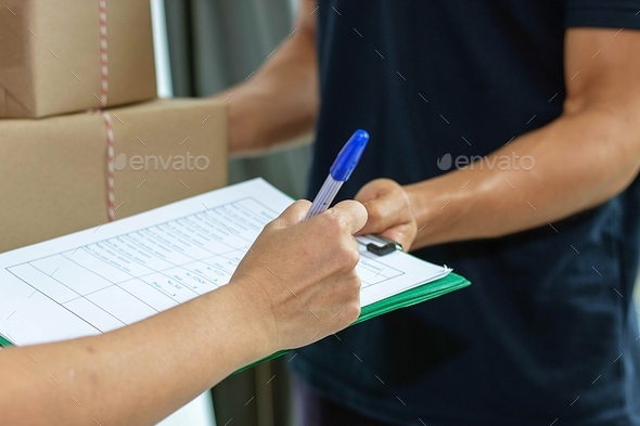 Customer is signing to receive shipment from dilivery Stock Photo by ...