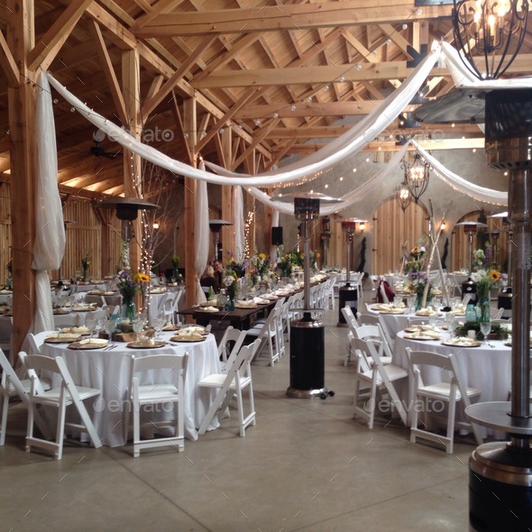 Wedding reception venue inside a timber frame barn here set up Stock ...