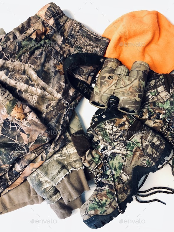 Flat lay items of a woman’s hunting outfit. Stock Photo by marisap7