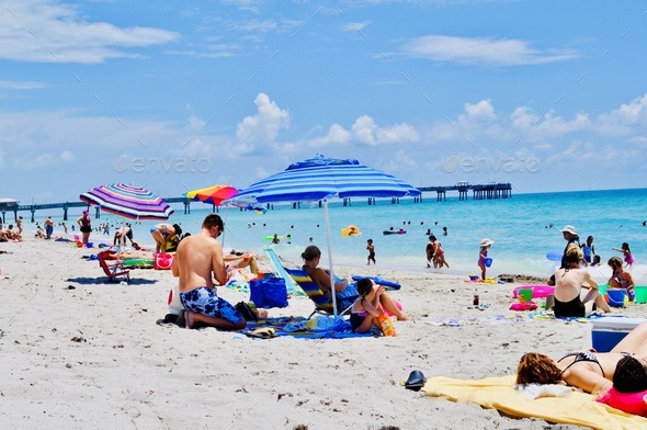 People enjoying a day at the beach. Stock Photo by marisap7 | PhotoDune