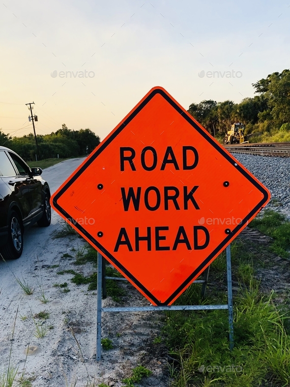 Red road work caution sign. Stock Photo by marisap7 | PhotoDune