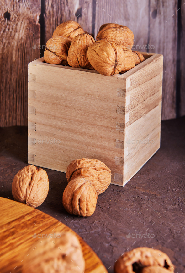Walnuts in a wooden box, whole and finely chopped, next to the filling ...