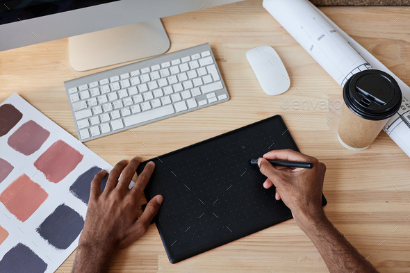 Male designer using pen tablet at workplace Stock Photo by ...