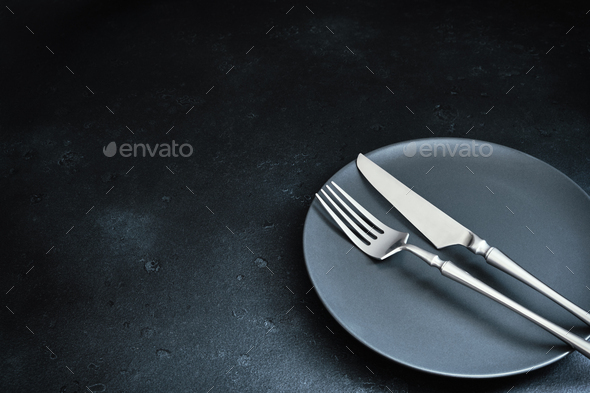 Cutlery on dark textured background. Table setting Stock Photo by TaniaJoy