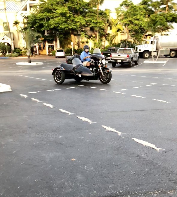 Active senior riding his motorcycle with a sidecar. Stock Photo by marisap7