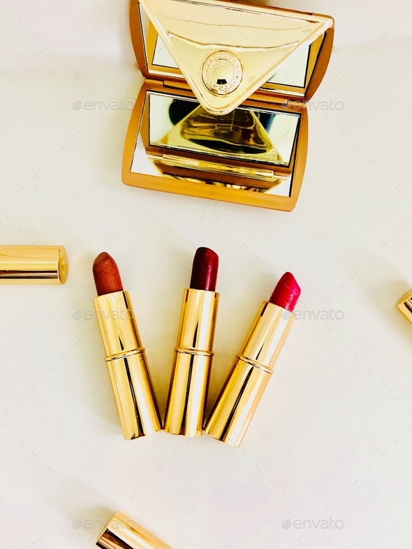 Flat lay makeup multiple colors of lipstick and a mirror. Stock Photo ...