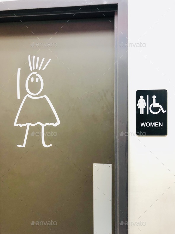 Etched drawing of a woman on a public restroom. Stock Photo by marisap7