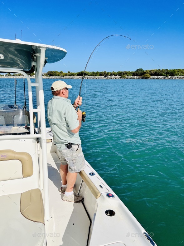 Reeling in a fish. Stock Photo by marisap7 | PhotoDune