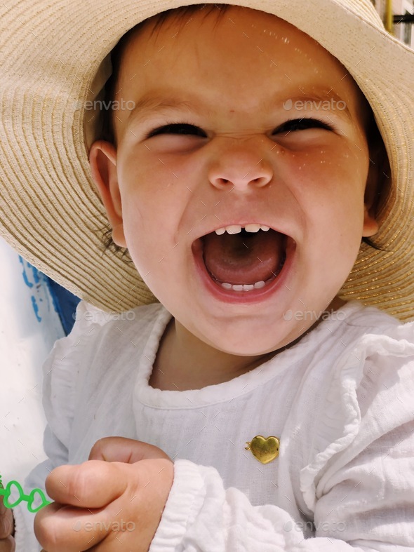 Happy baby with teeth and hat in summer day Stock Photo by troyanpx