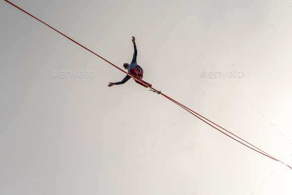 A man balancing on a tight rope. Stock Photo by Javanng | PhotoDune
