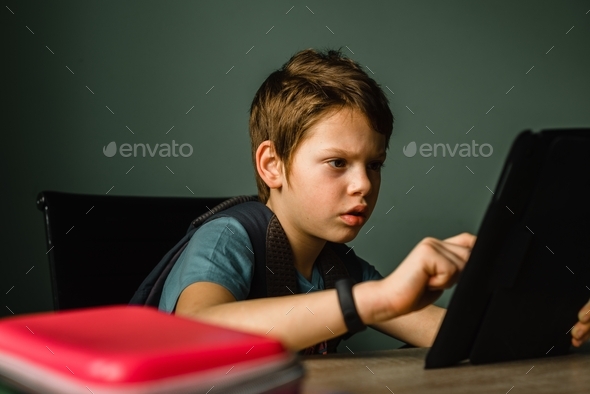 School boy using tablet at home, growing up with technology Stock Photo ...