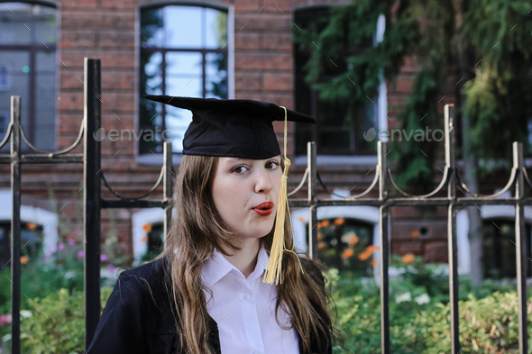 Cute teenage graduate girl laughing and having fun. No school, back to ...