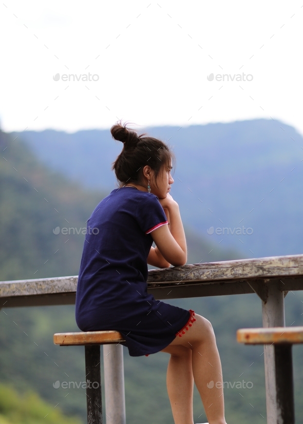 Teenager girl sitting thought in nature mountain landscape blur outdoor ...