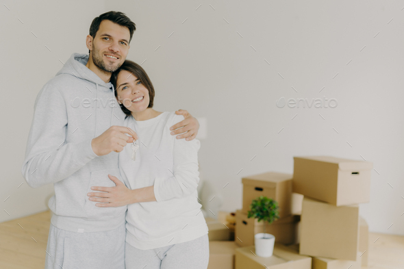 Couple in love purchase own house, embrace and stand closely to each ...