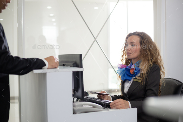 Female officer working at airline check in counter service at the ...