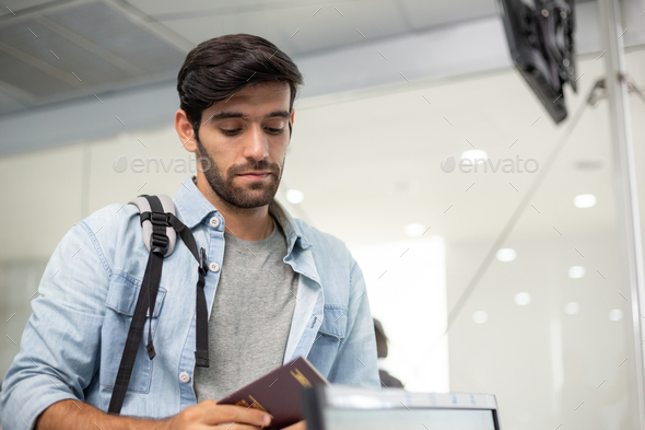 Caucasian tourist man check-in at airline counter service. Stock Photo ...