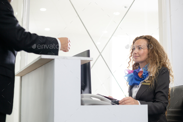Female officer working at airline check in counter service at the ...